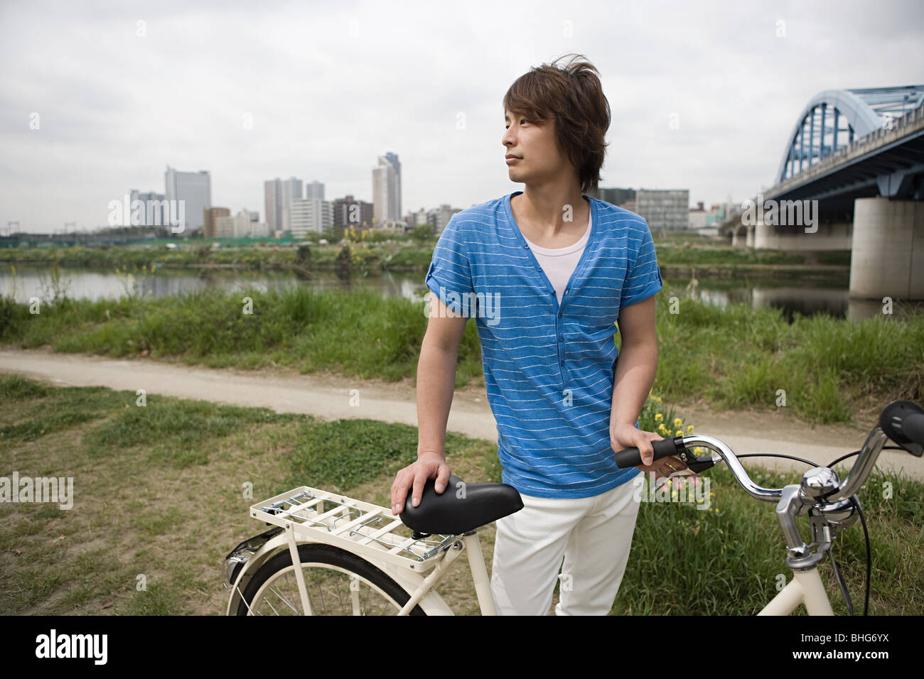 Young man with bicycle Stock Photo - Alamy