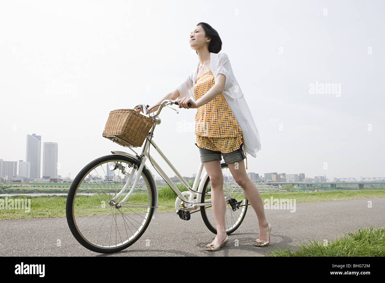 Young woman with bicycle Stock Photo - Alamy