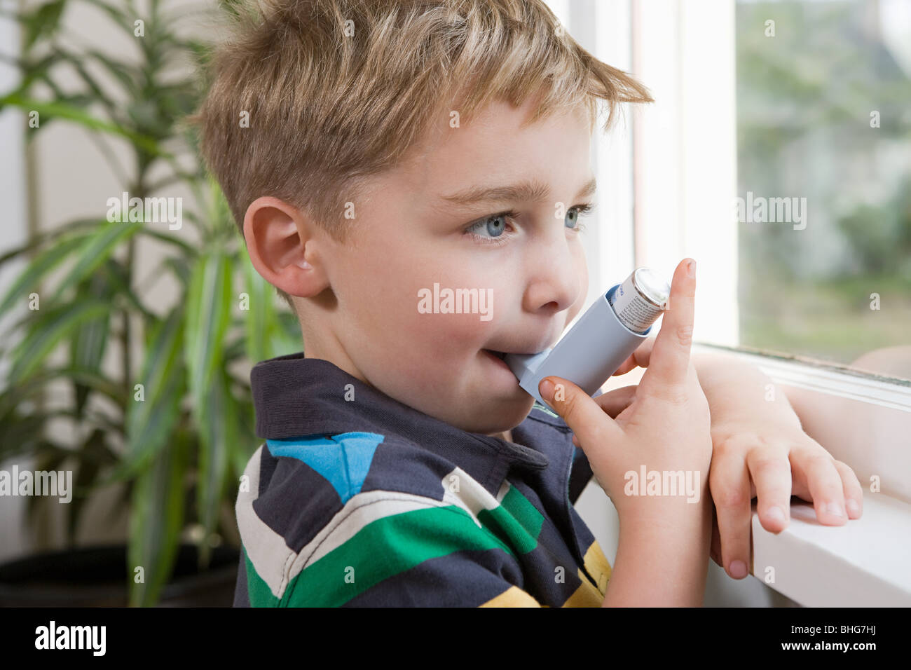 Boy taking asthma inhaler Stock Photo - Alamy