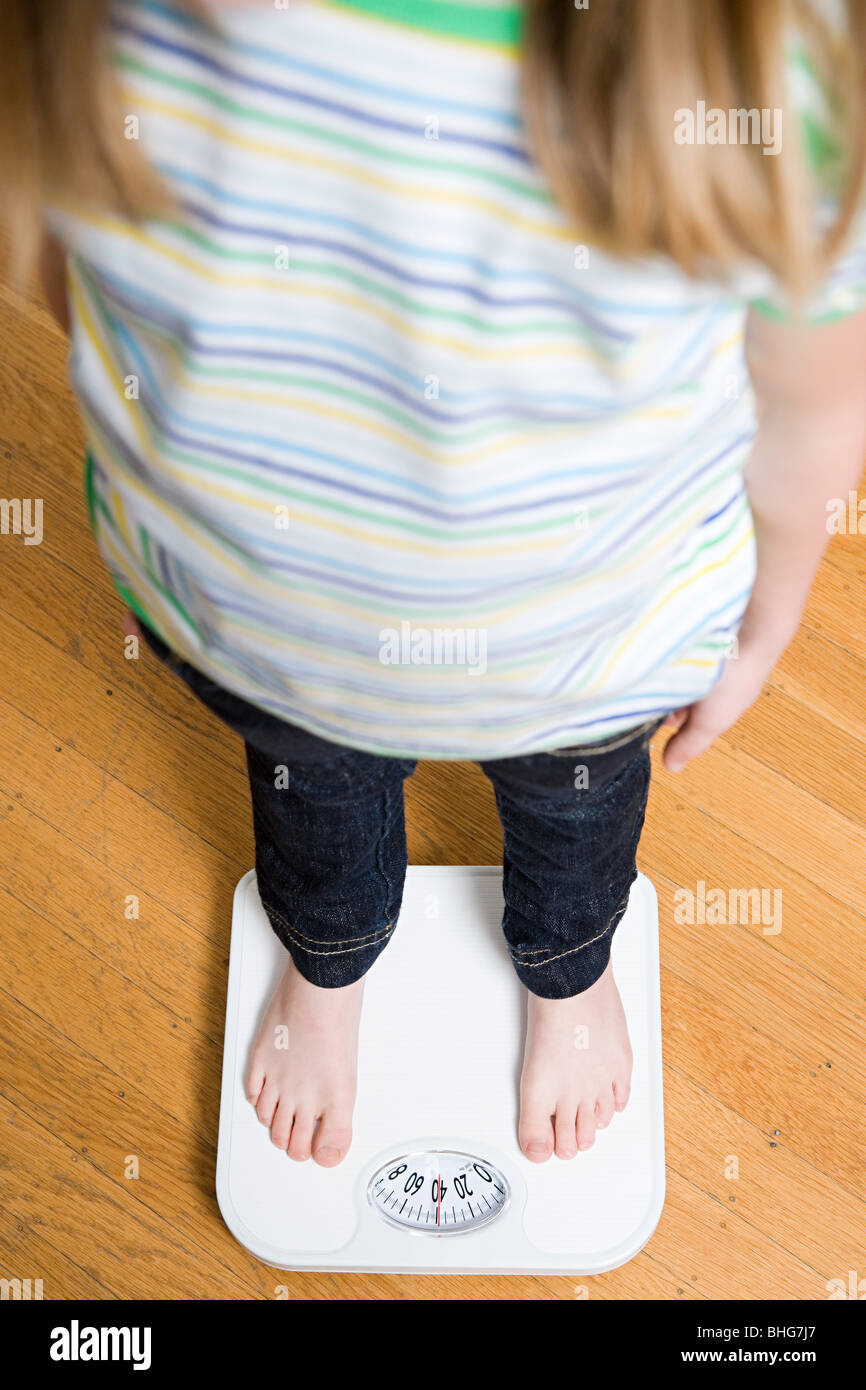 Child on weighing scales hi-res stock photography and images - Alamy