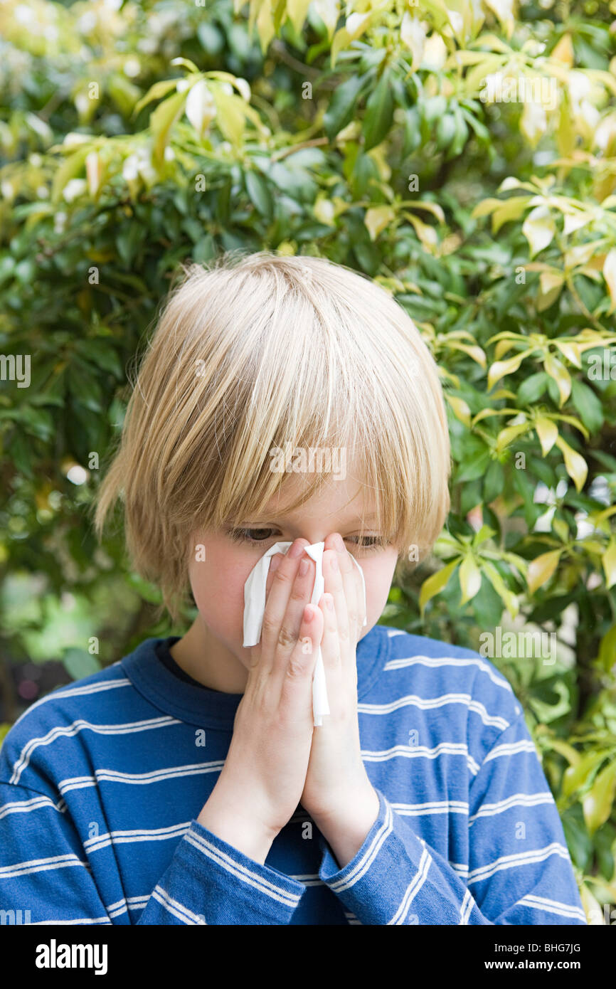 Boy blowing his nose Stock Photo - Alamy