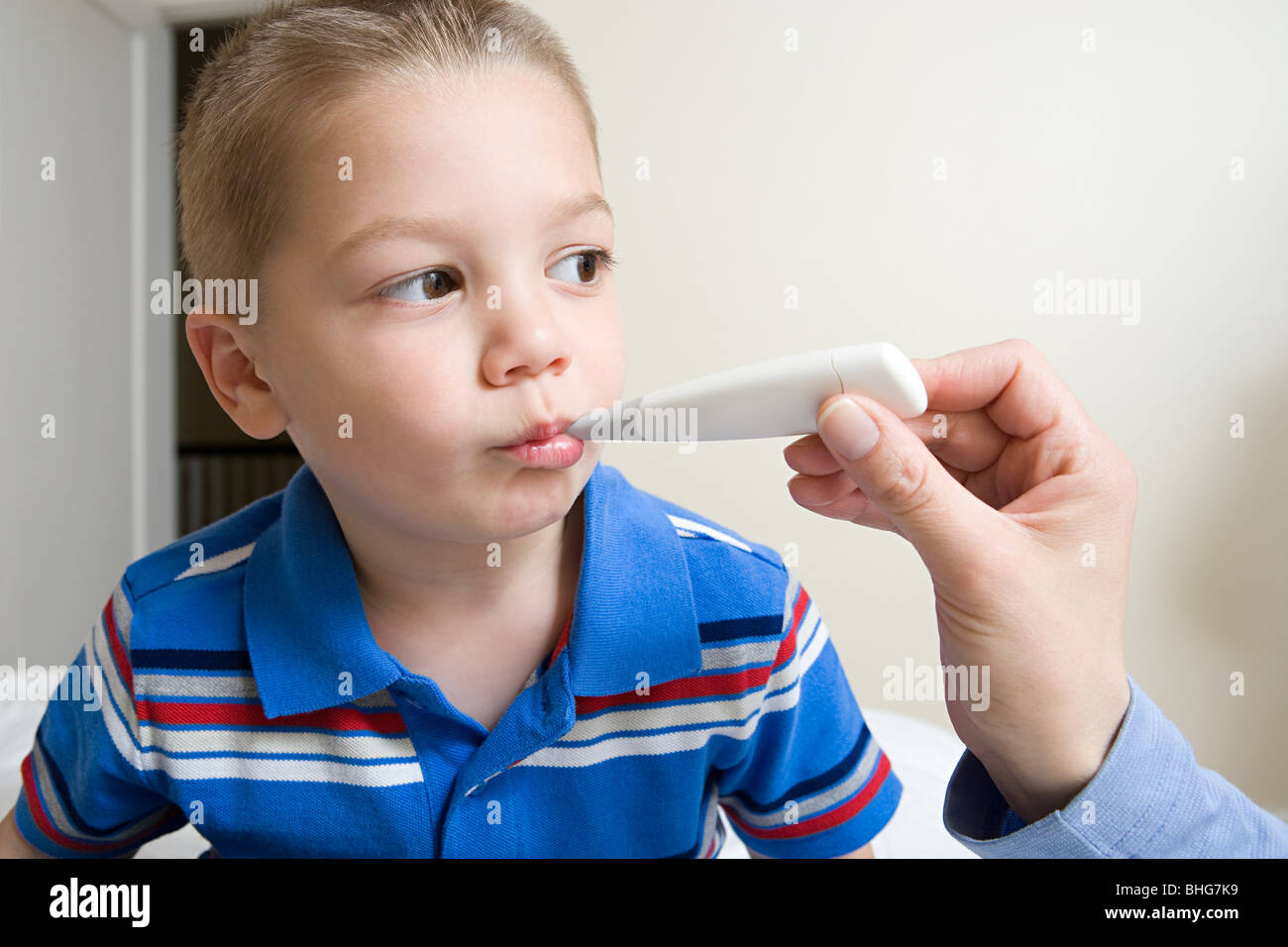 Boy having his temperature taken Stock Photo - Alamy
