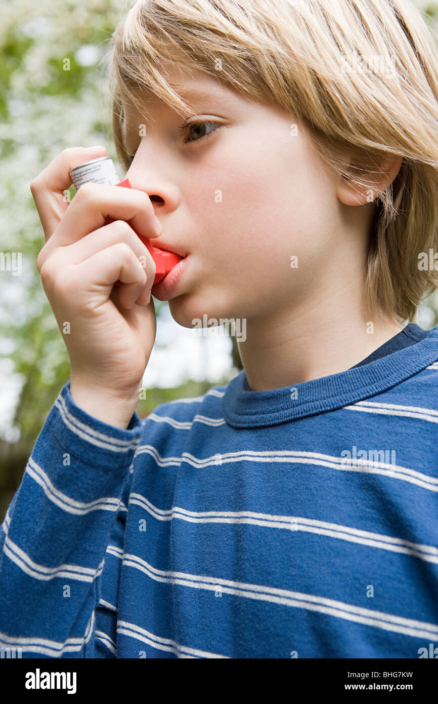 Boy taking asthma inhaler Stock Photo - Alamy
