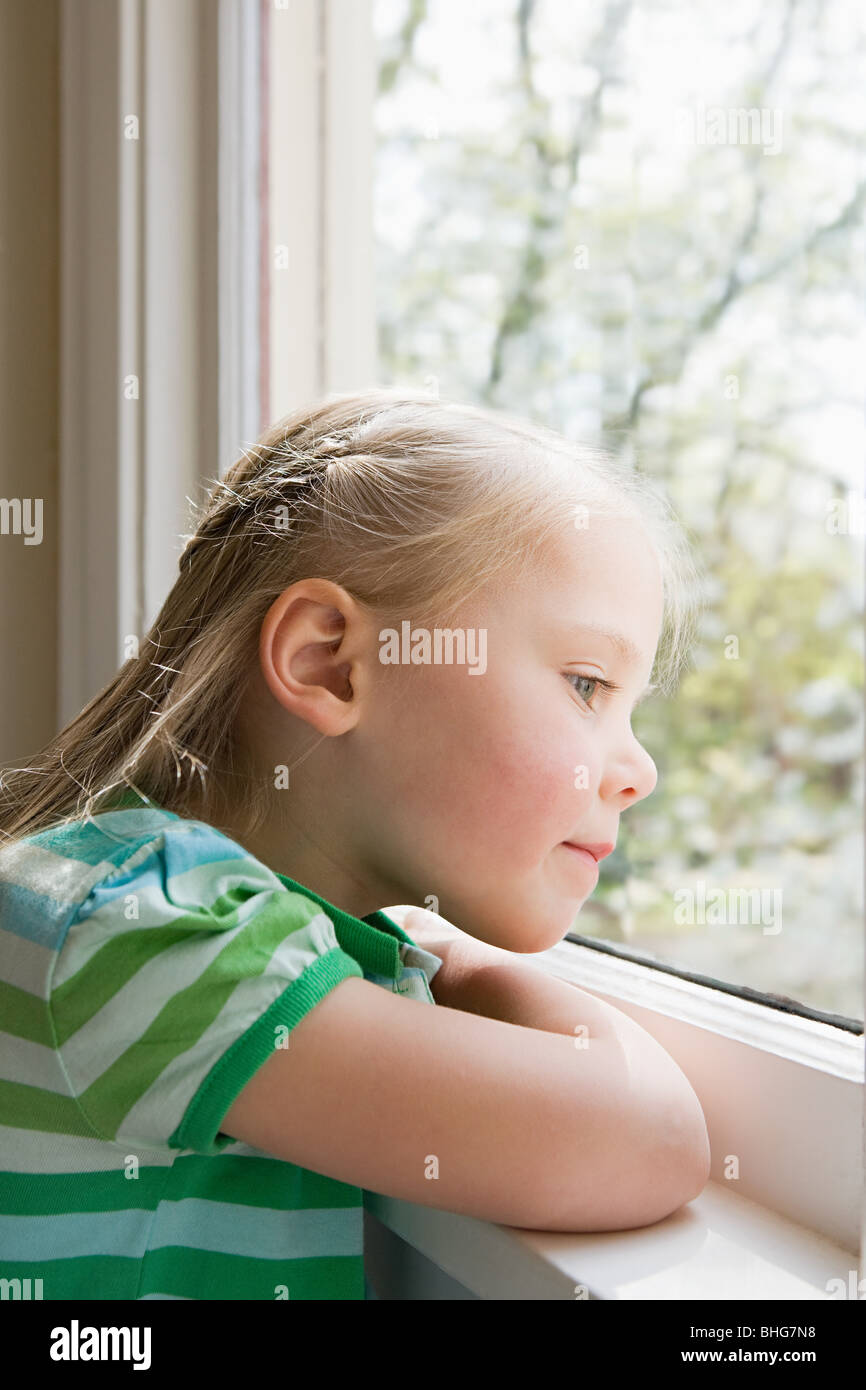Girl looking out of window Stock Photo - Alamy