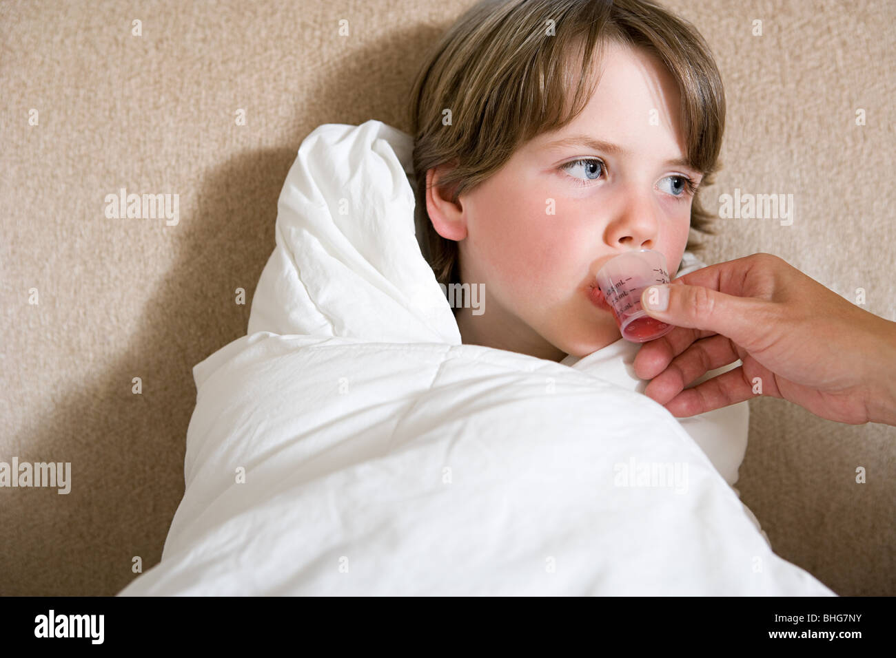 Boy being given medicine Stock Photo - Alamy