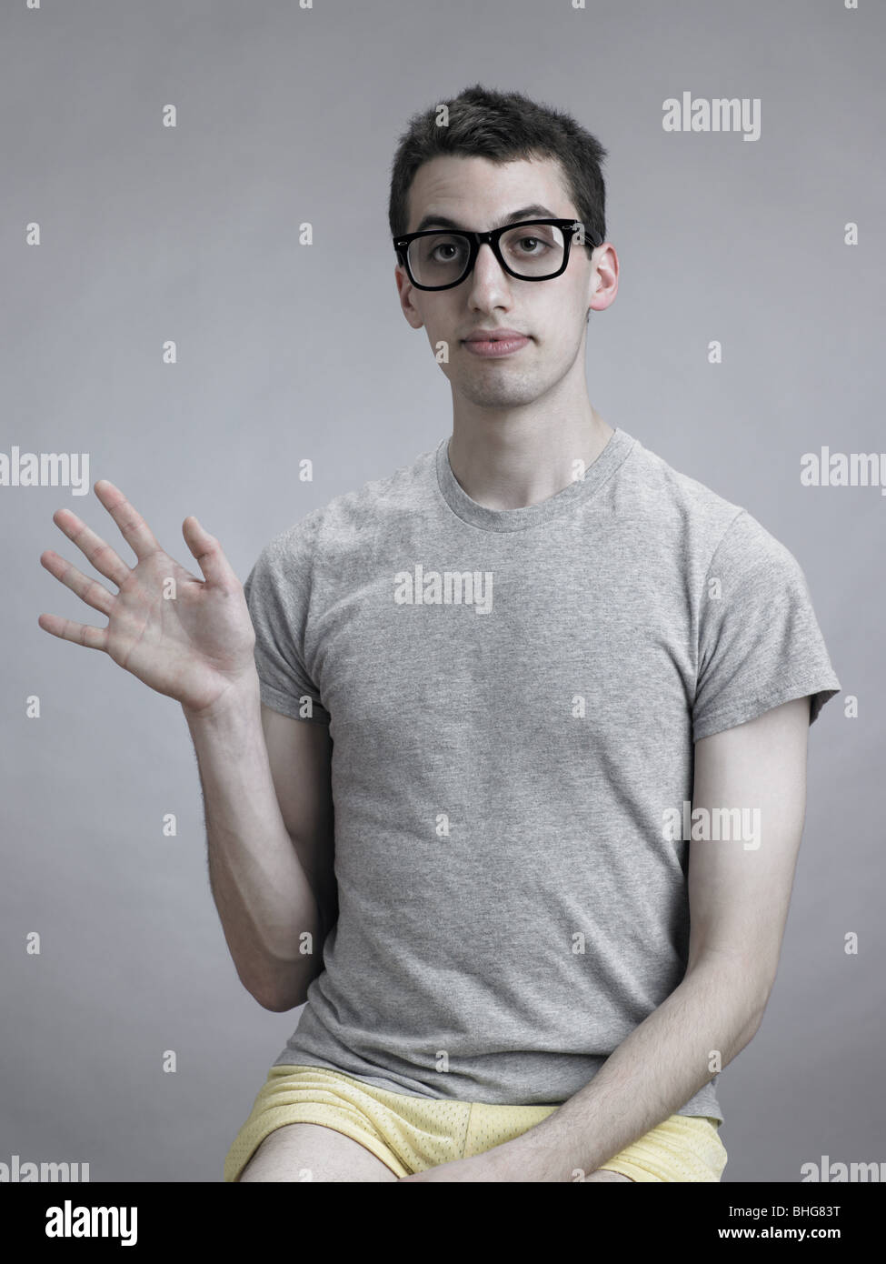 Young man waving Stock Photo - Alamy