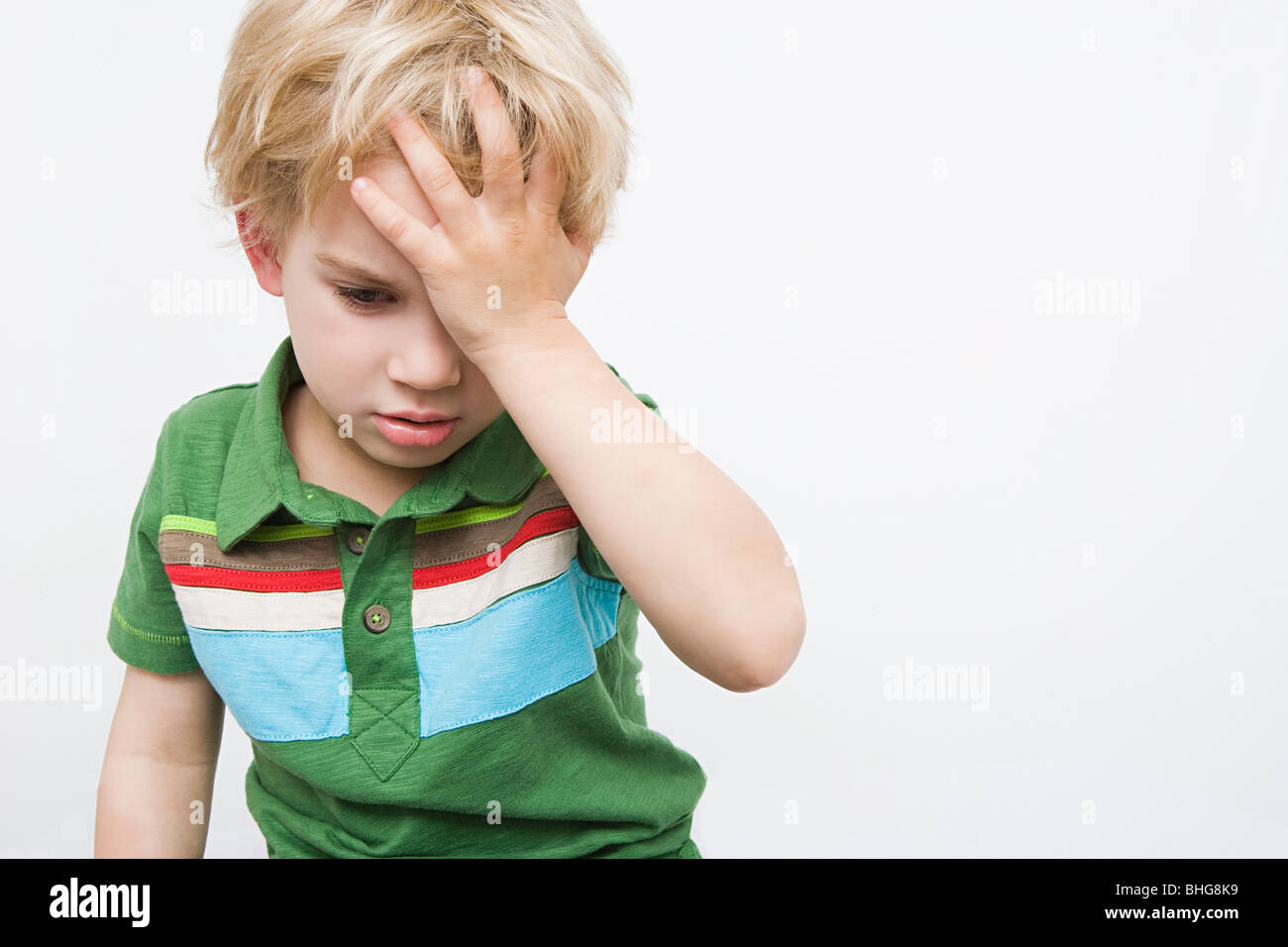 Boy with hand on head Stock Photo - Alamy