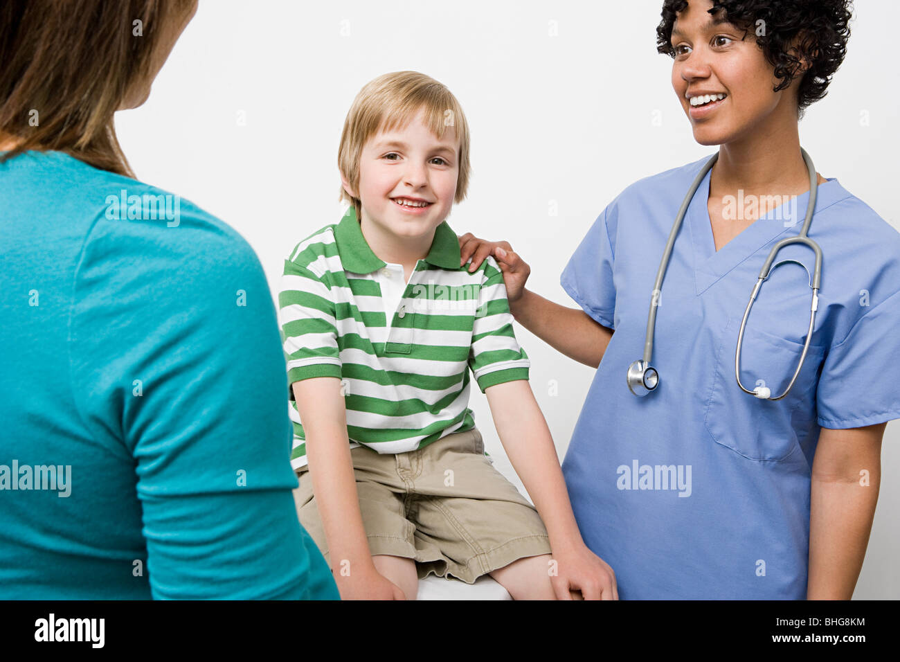 Boy with nurse and parent Stock Photo - Alamy