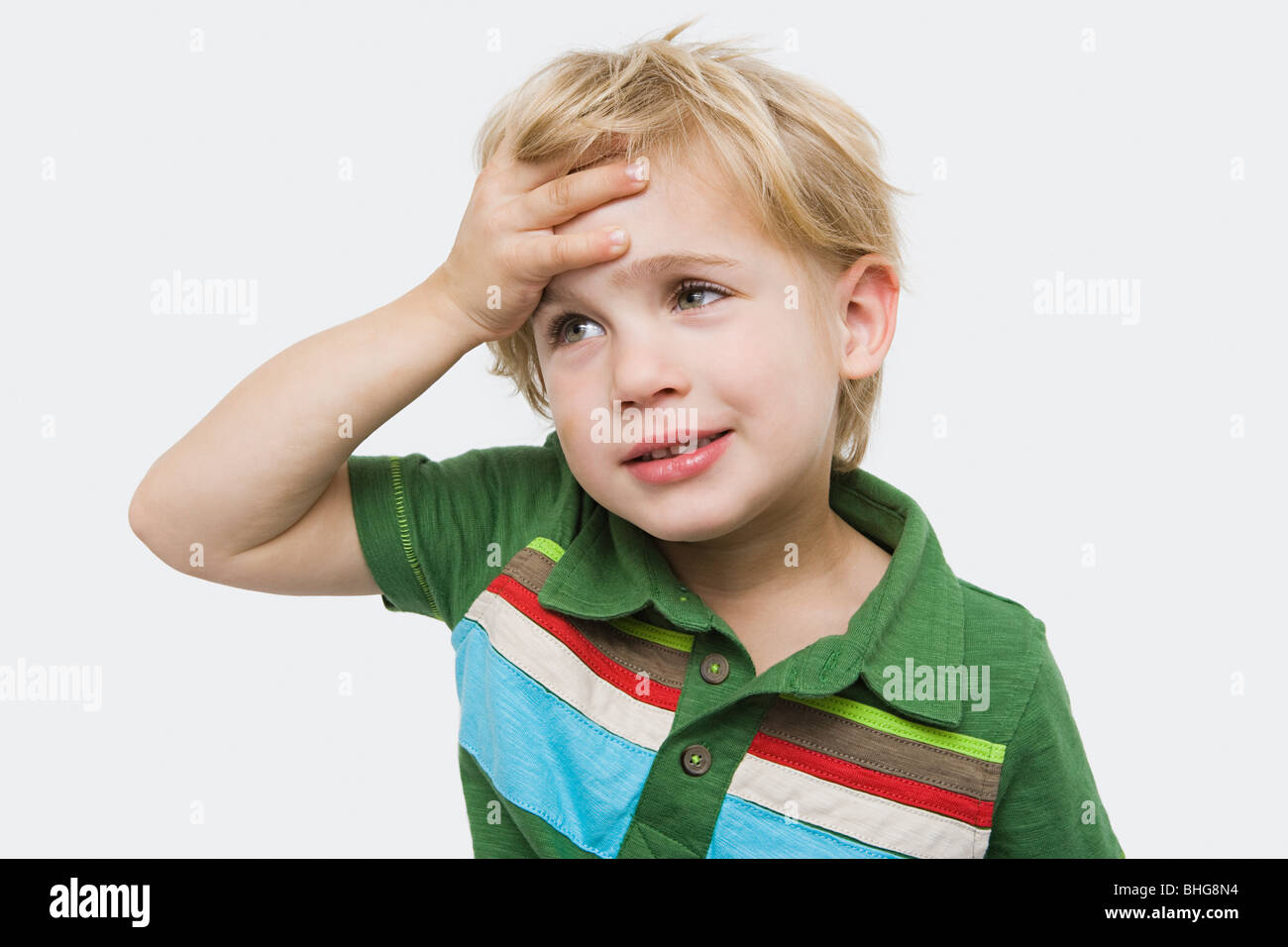 Boy with hand on head Stock Photo - Alamy