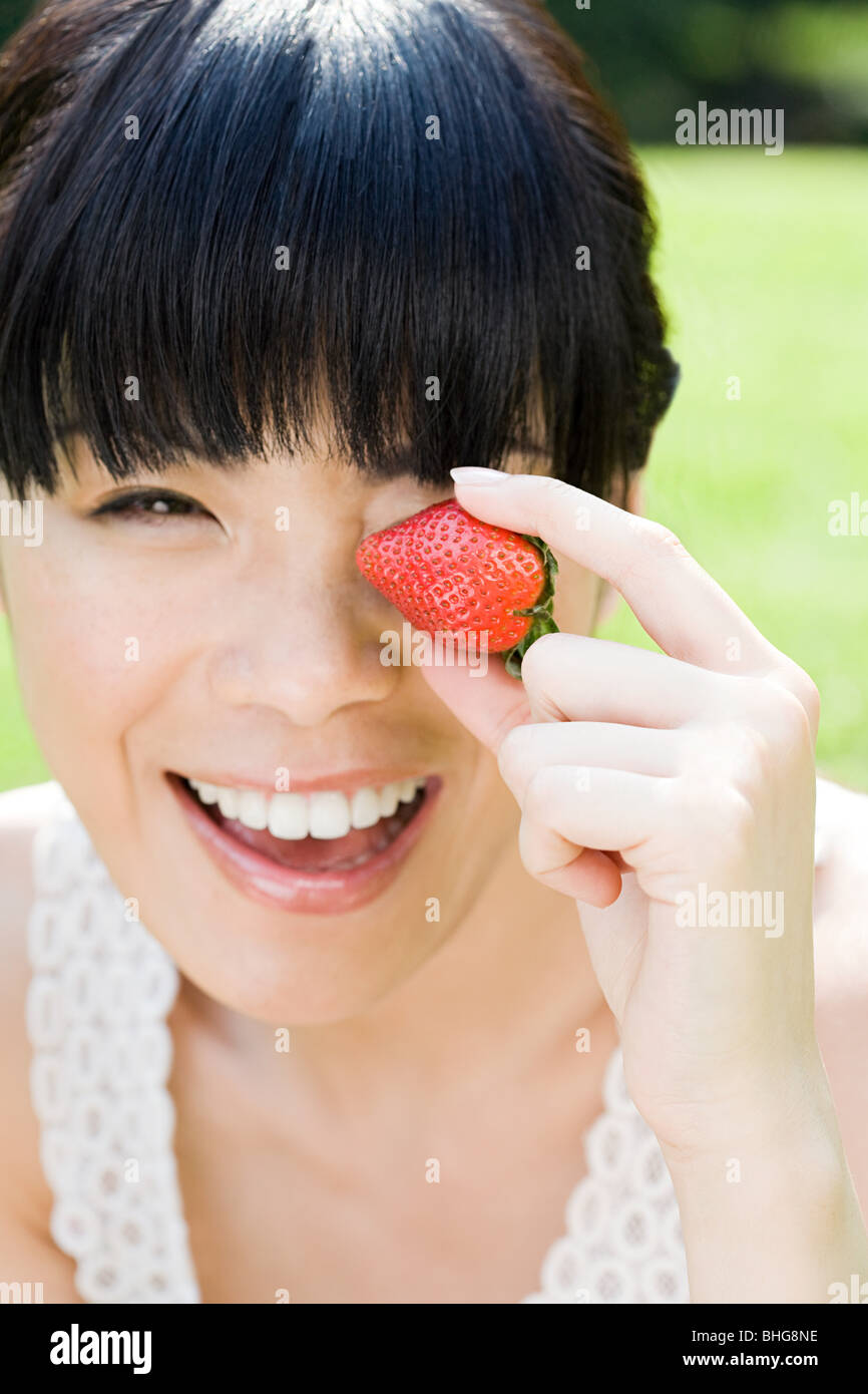 Young woman with strawberry Stock Photo - Alamy