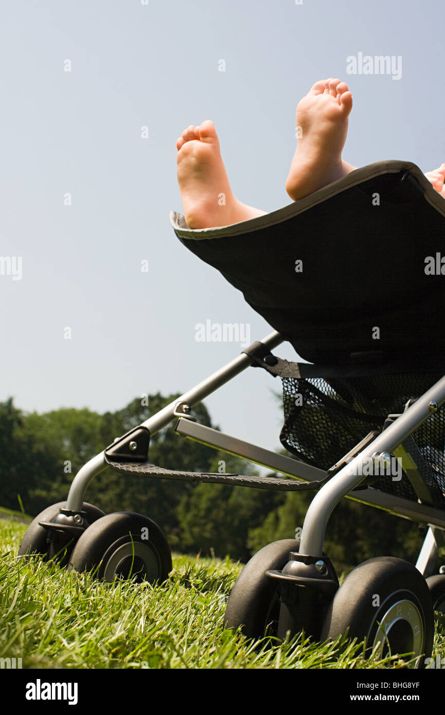 Feet of baby in push chair Stock Photo - Alamy