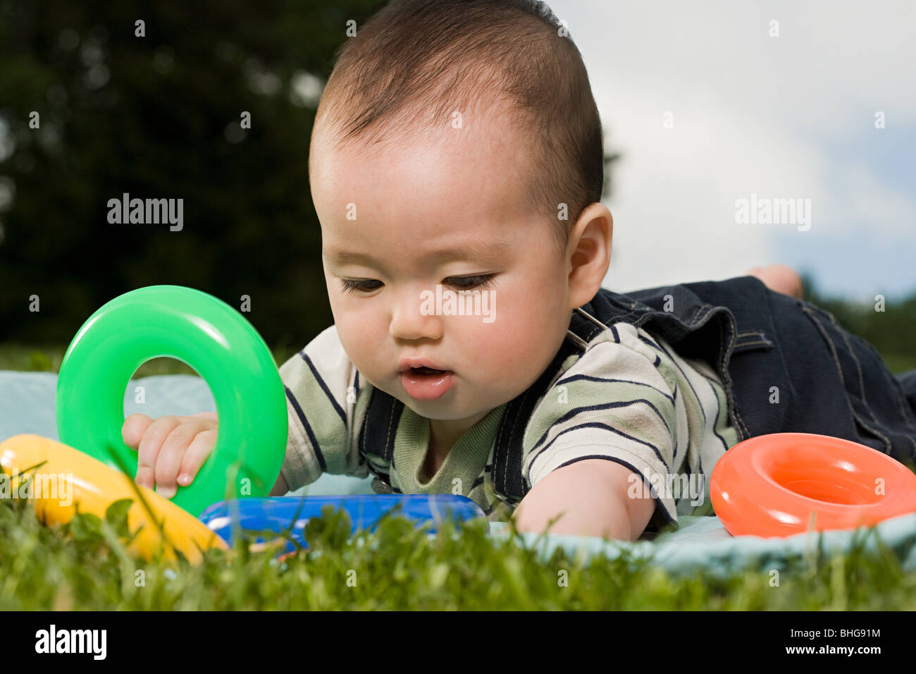 Baby playing with plastic rings Stock Photo - Alamy
