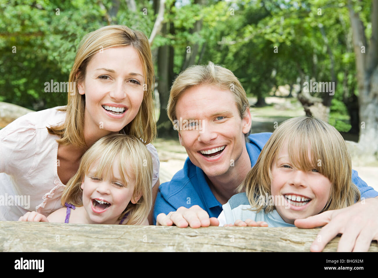 Family by a log Stock Photo - Alamy