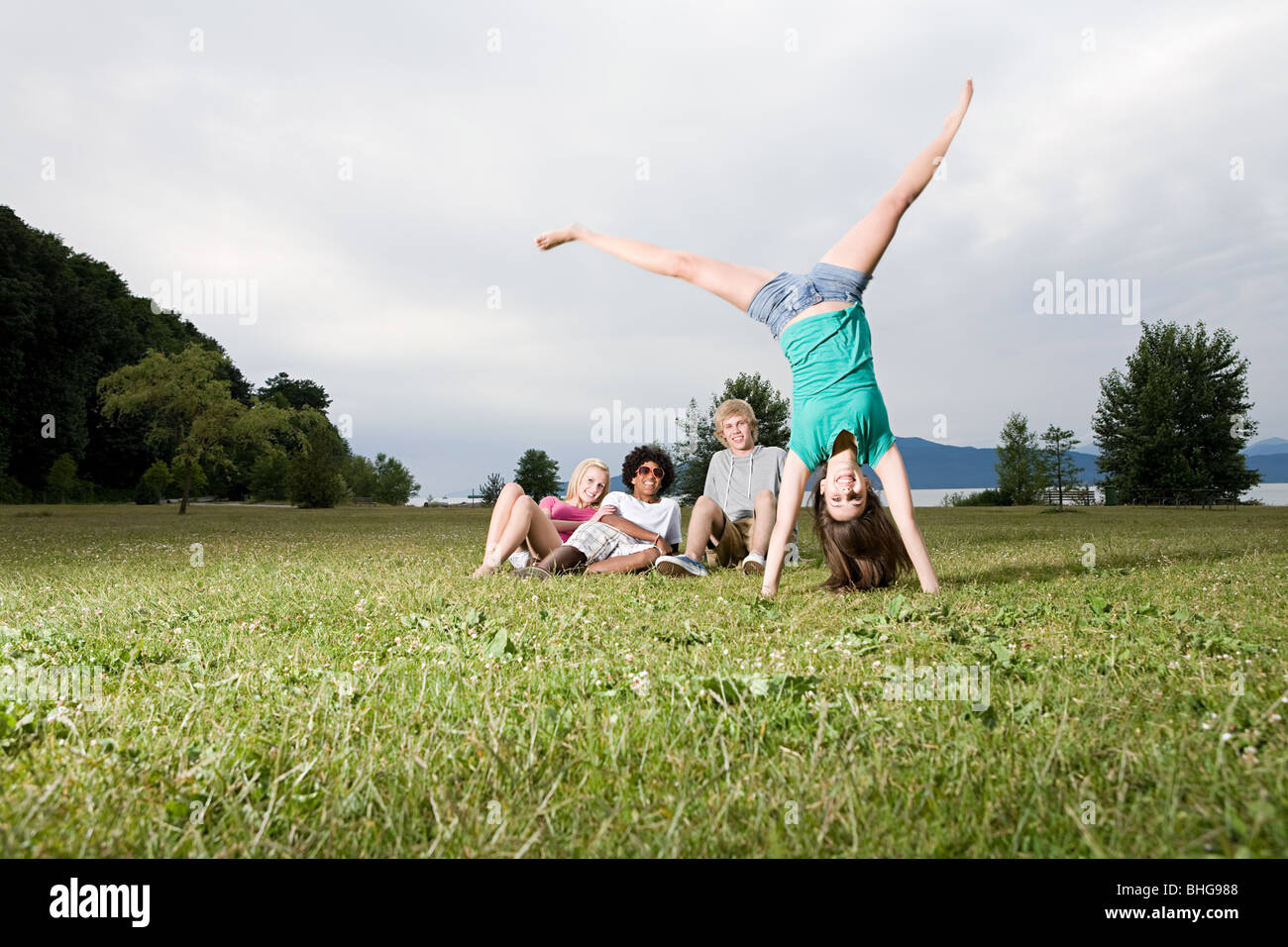 Teenage girl going handstand Stock Photo - Alamy