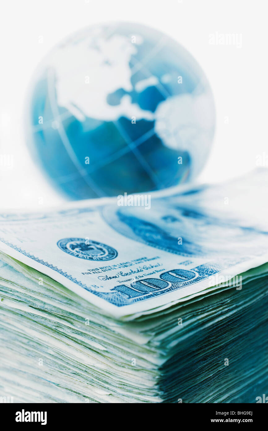Stack of banknotes and globe Stock Photo - Alamy