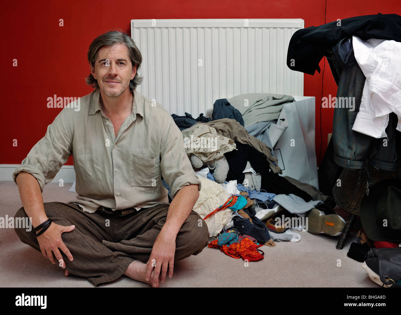 man with pile of clothes Stock Photo - Alamy