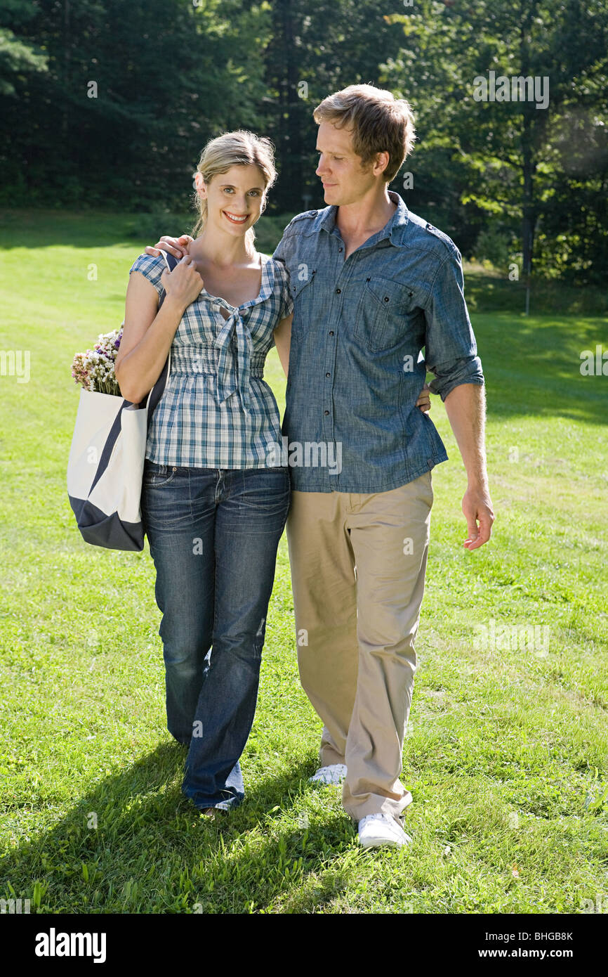 Couple arm shoulder walking hi-res stock photography and images - Alamy