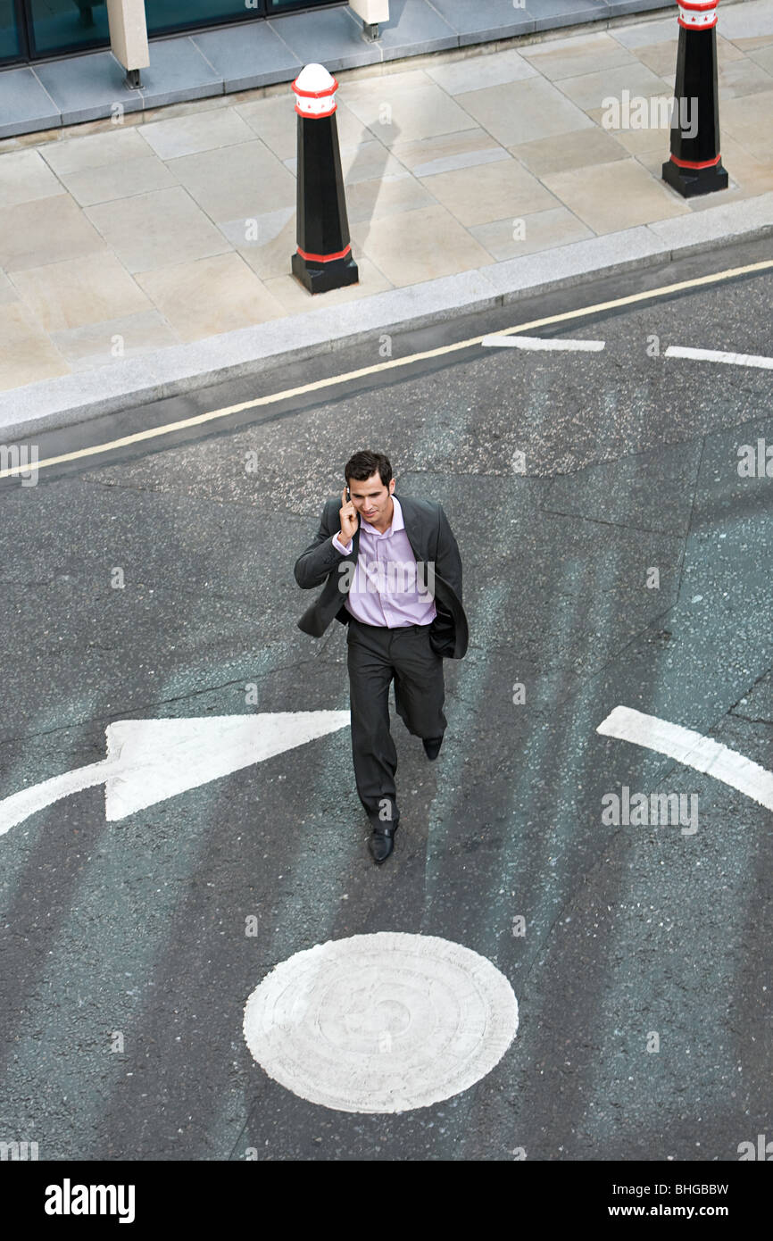 Businessman crossing the street Stock Photo - Alamy