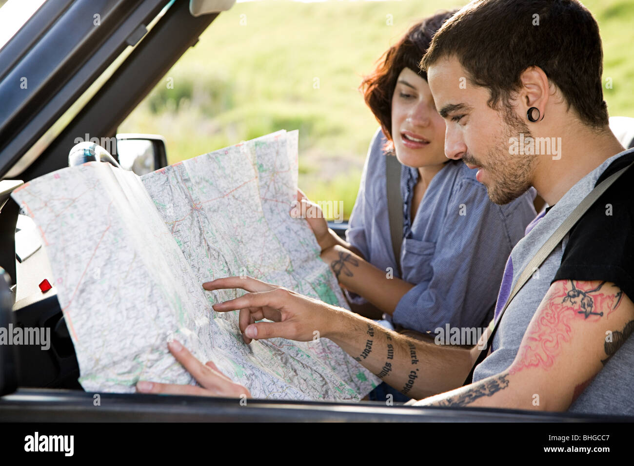 Couple looking at map Stock Photo - Alamy