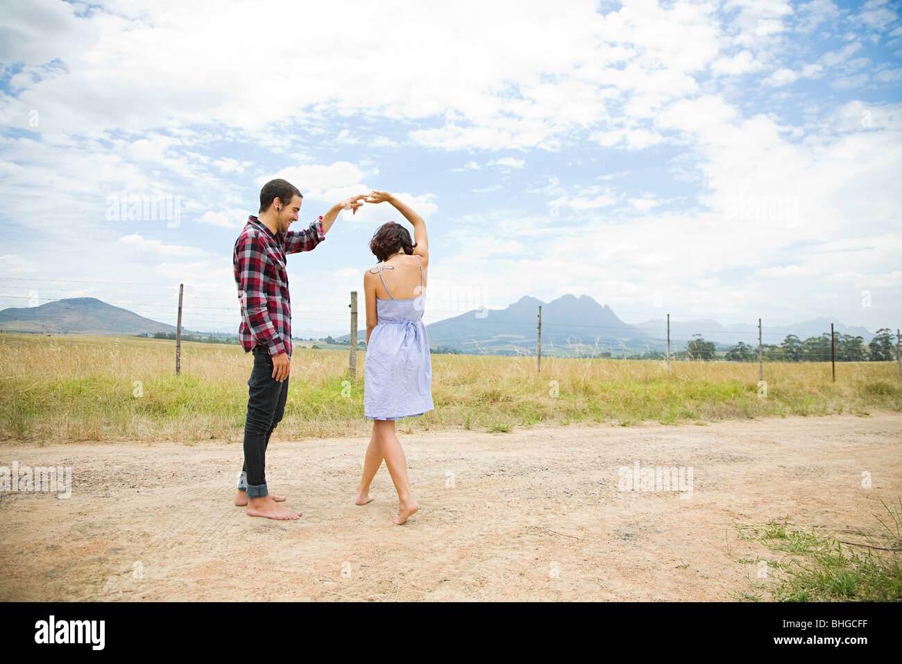 Couple dancing in a field Stock Photo - Alamy