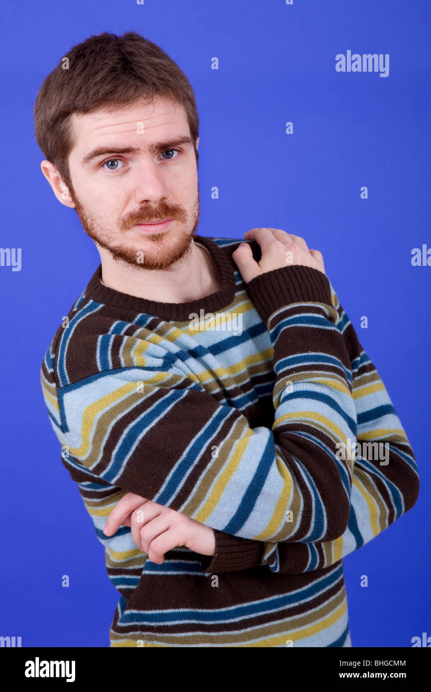 an young man portrait over a blue background Stock Photo - Alamy