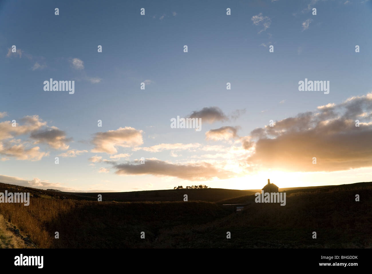 Sunsert and an old water board house above Redmires Dams, Sheffield, UK ...