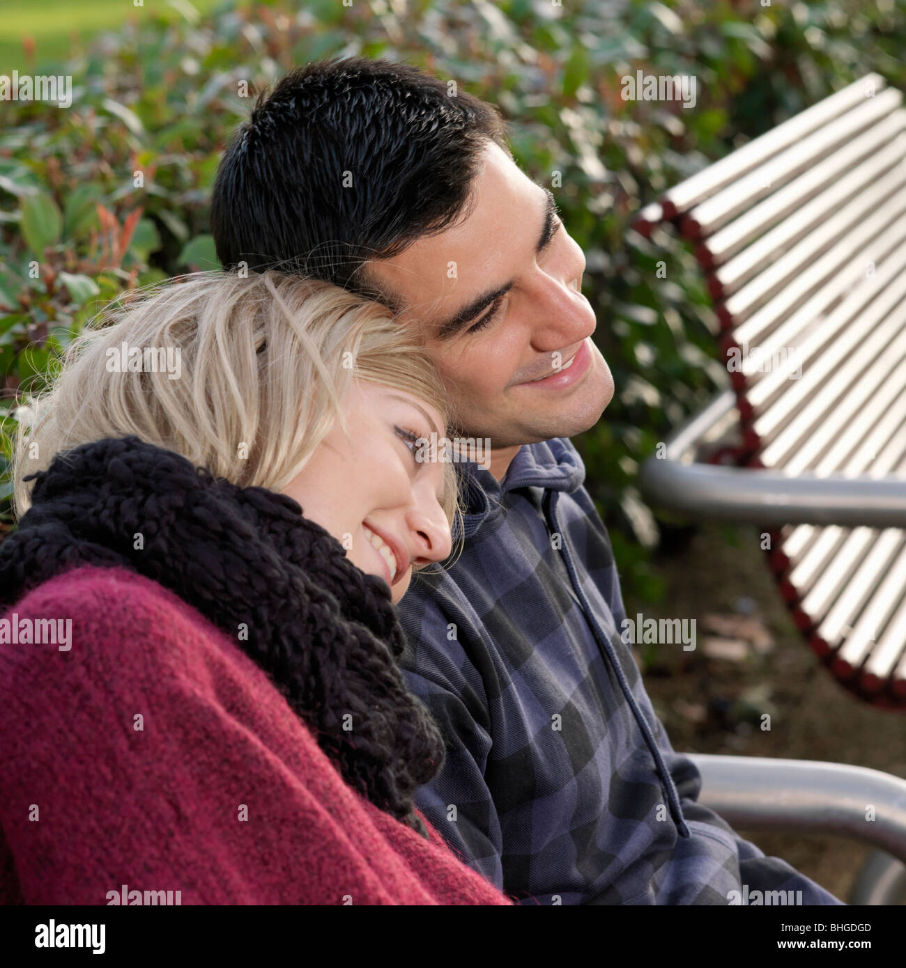 couple sitting on bench Stock Photo - Alamy