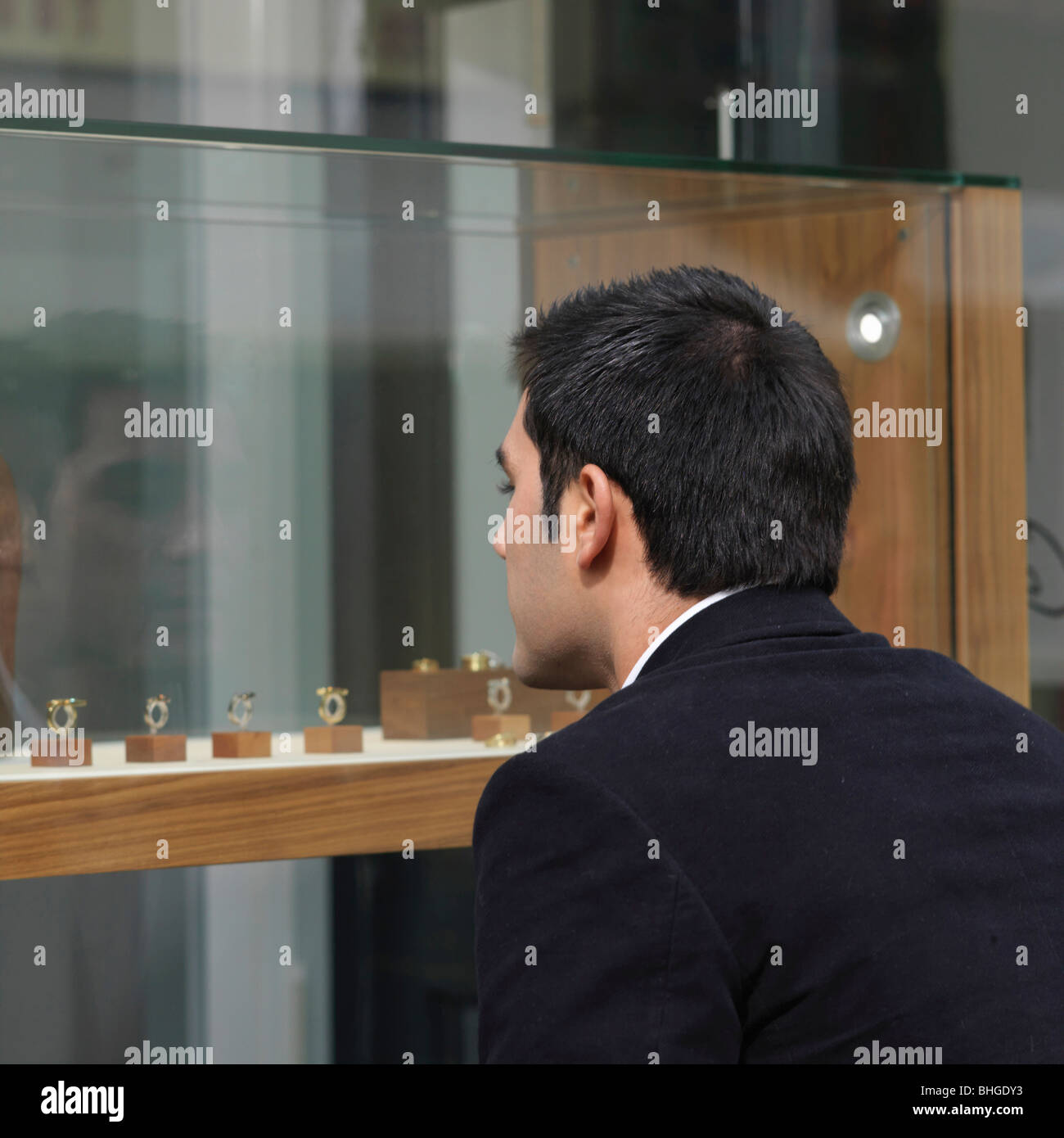 man looking at jewelry in shop window Stock Photo - Alamy