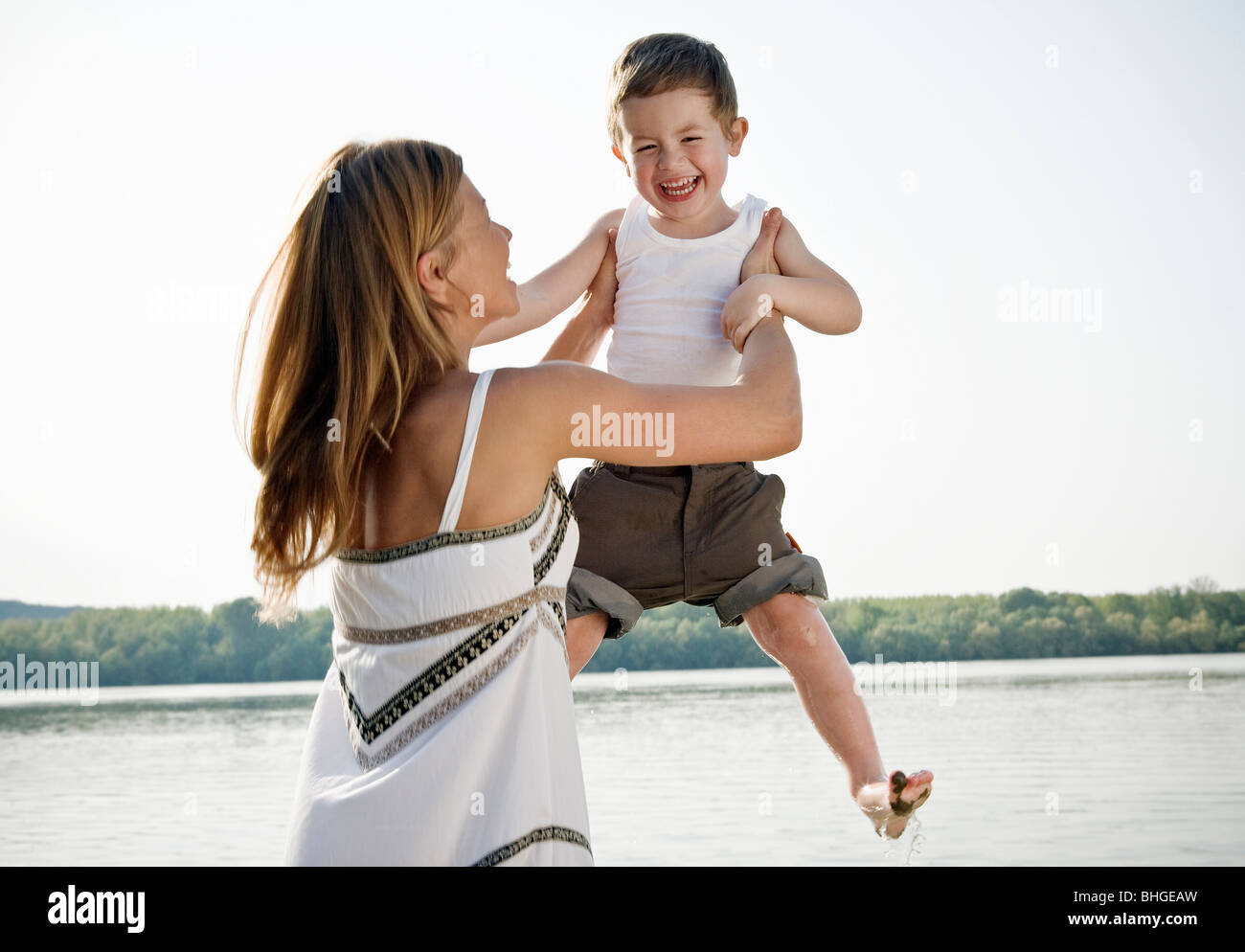 Mother lifting child in air Stock Photo - Alamy