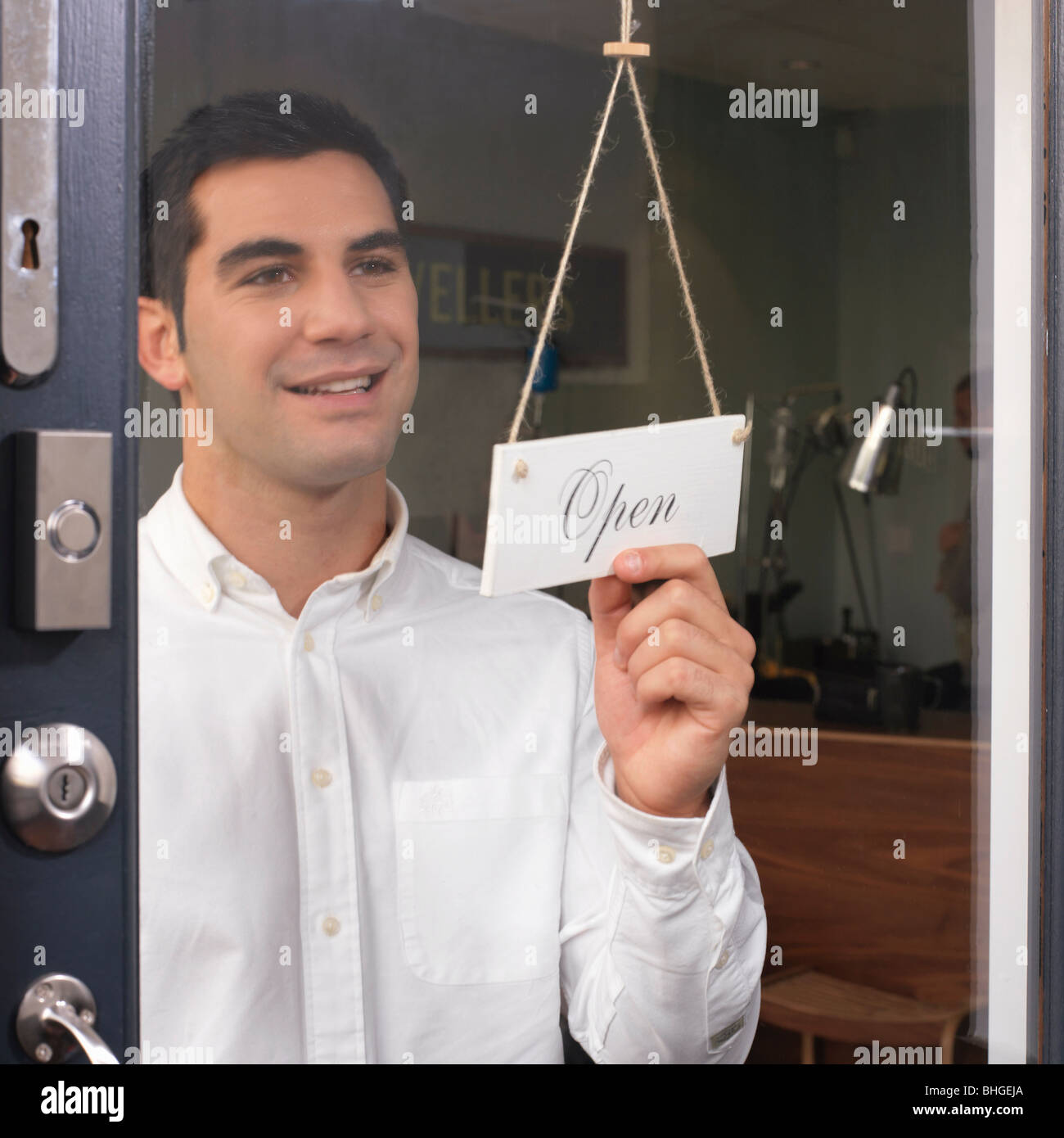 man at door saying 'open' Stock Photo - Alamy