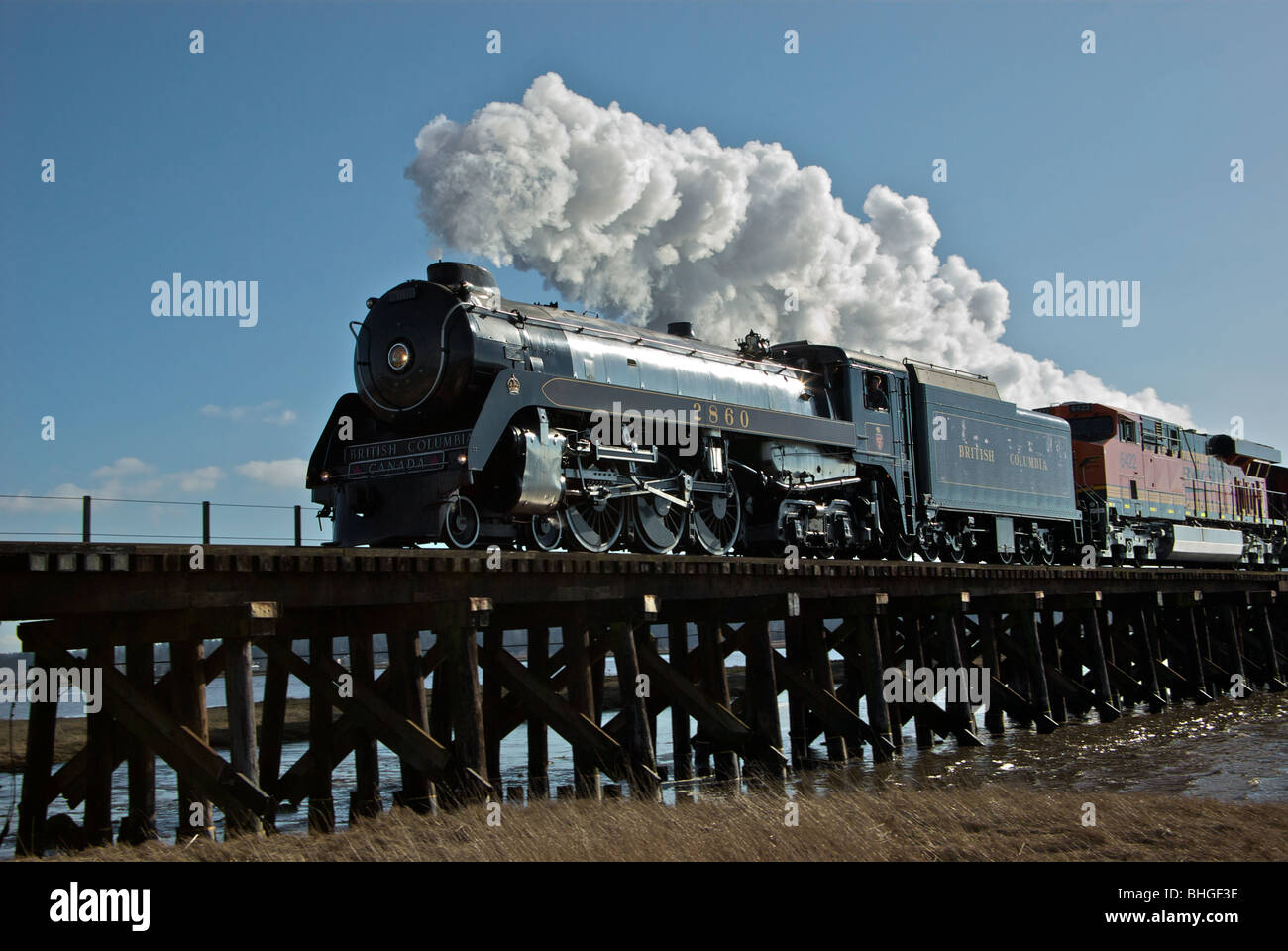 Restored CPR Royal Hudson 2860 steam engine crossing Serpentine River ...