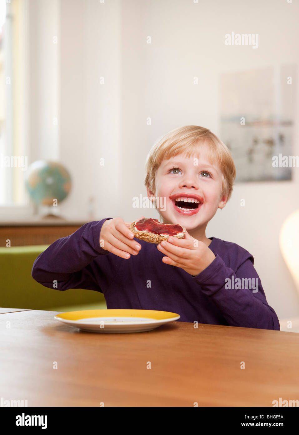 boy eating bread roll Stock Photo - Alamy