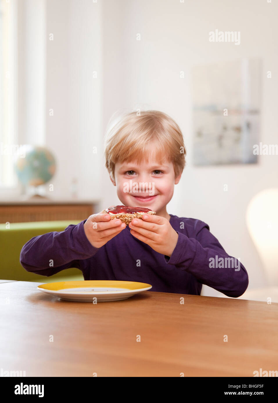 boy eating bread roll Stock Photo - Alamy