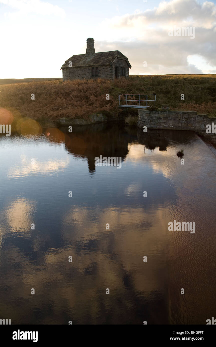 An old water board house above Redmires Dams, Sheffield, UK reflected ...