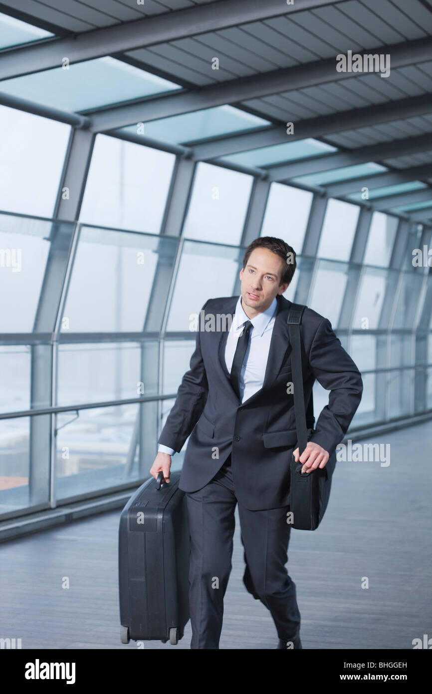 businessman with case hurrying Stock Photo - Alamy