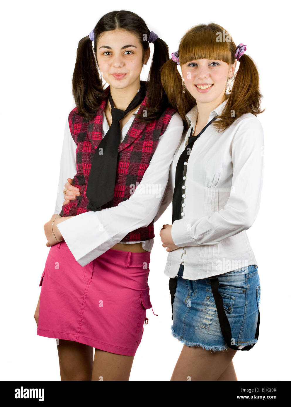 Two schoolgirls friends isolated on white background Stock Photo - Alamy