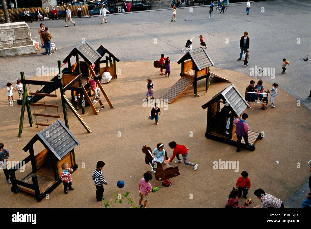 FRANCE MULTI ETHNIC FAMILIES PLAYING IN A PLAYGROUND IN MONTMARTRE ...