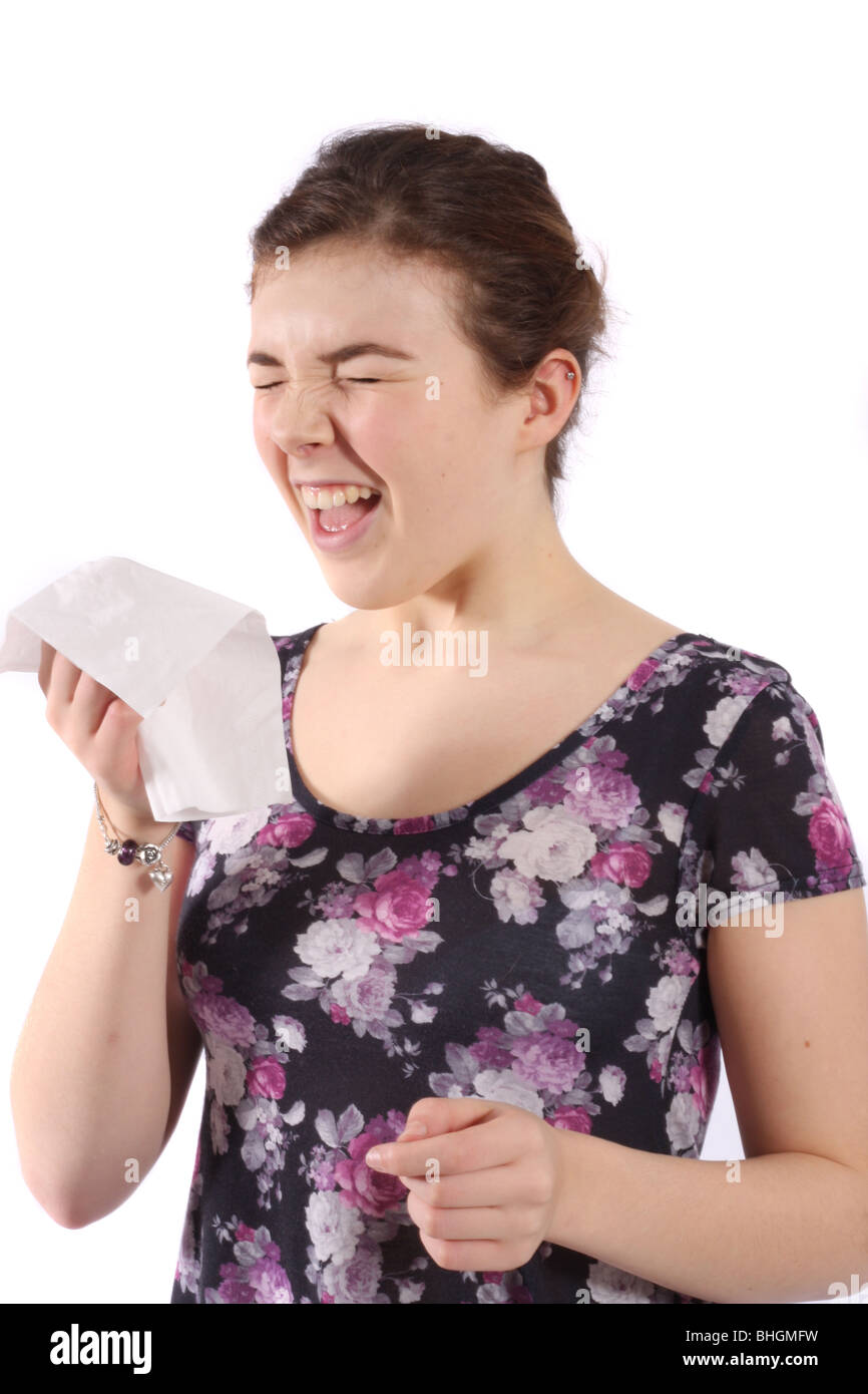 A girl sneezing into a tissue Stock Photo - Alamy