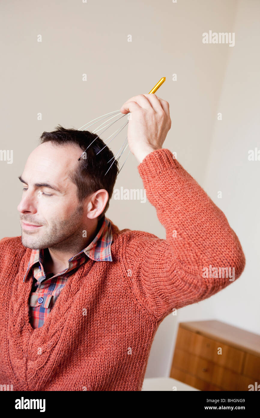 man using scalp massage instrument Stock Photo - Alamy