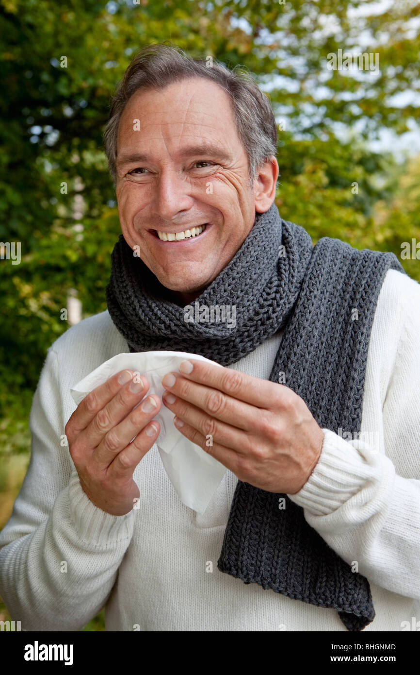 Middle aged man with scarf and tissue Stock Photo - Alamy