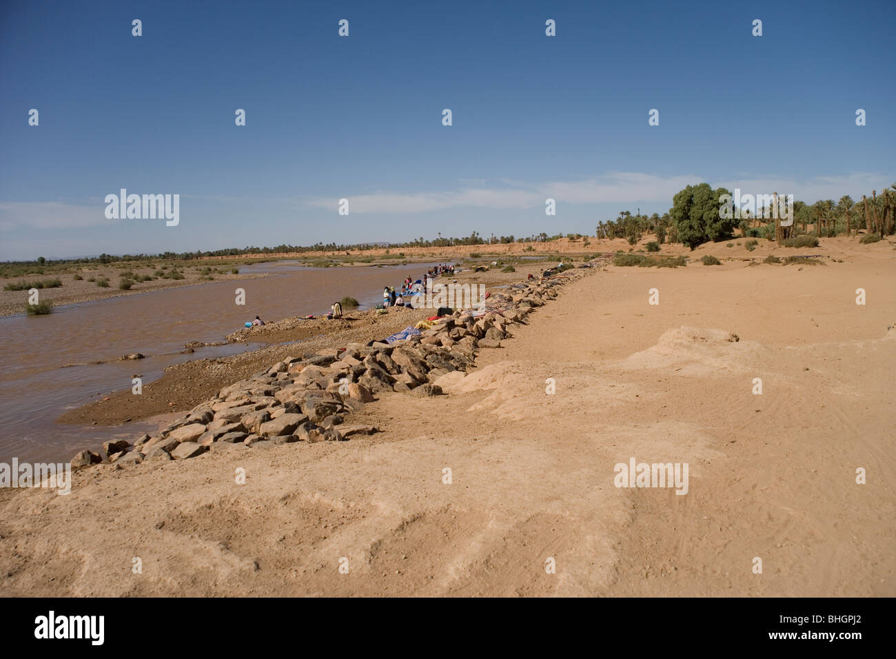 Arab women washing clothes in the Draa river in the village of Tinfou ...