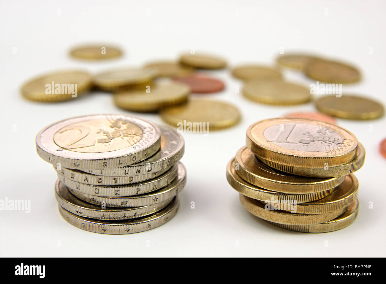 Metal coins on white background Stock Photo - Alamy