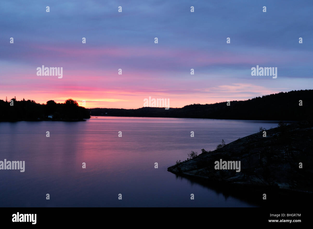 Dawn skies reflected in Simon Lake, Greater Sudbury, Ontario, Canada ...