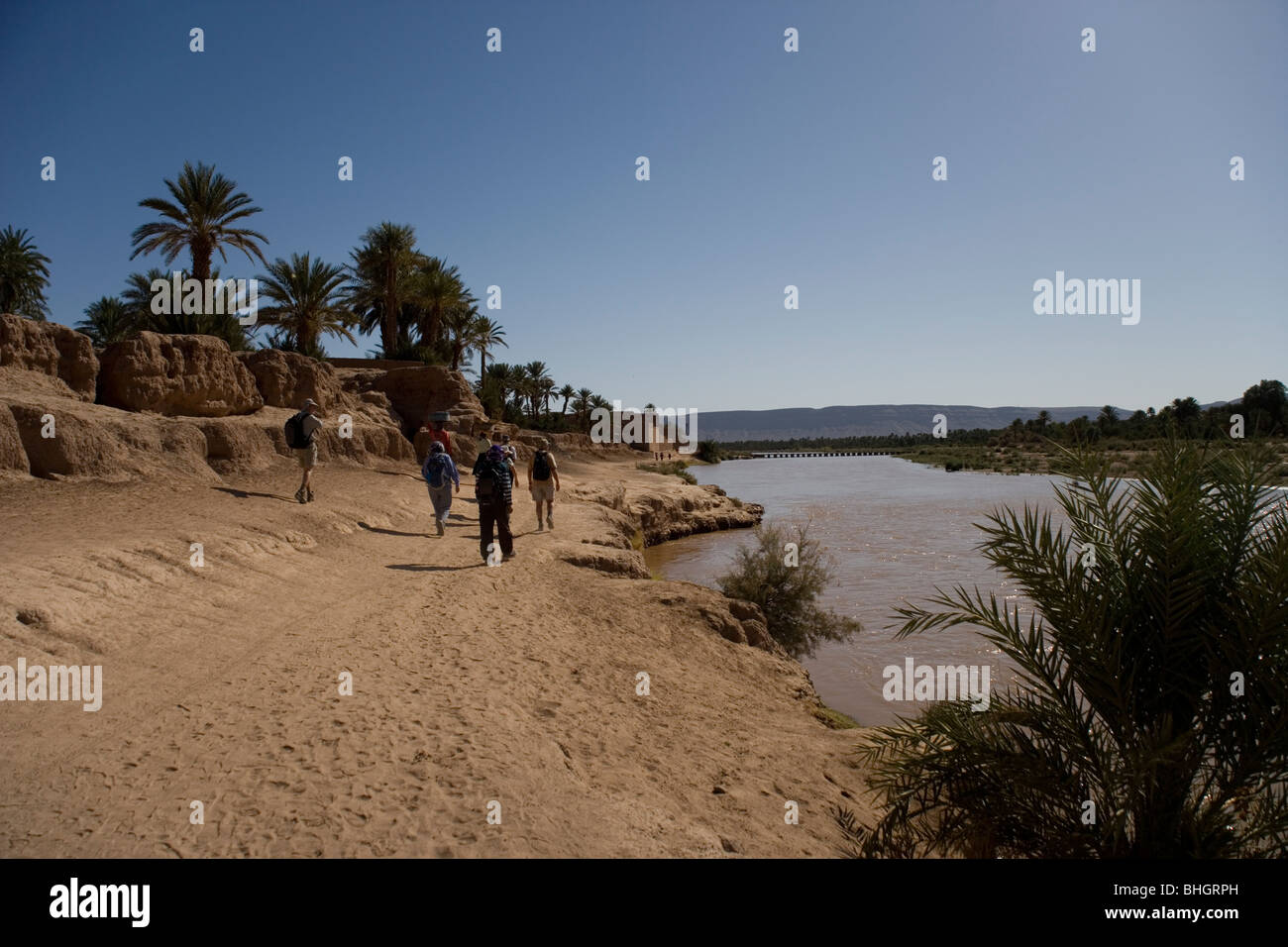 Walking by the Draa river in the village of Tinfou in the Sahara desert ...