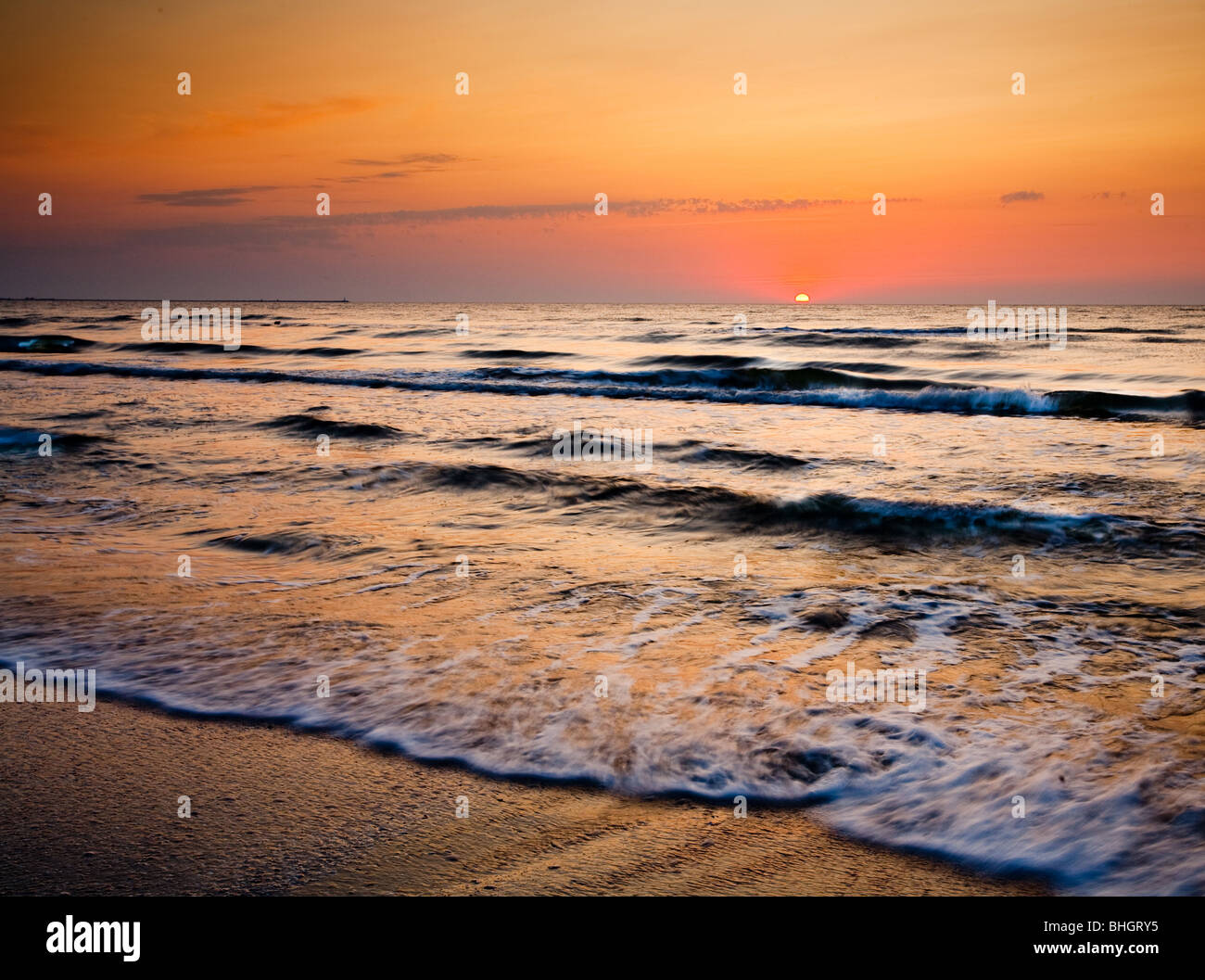 Sunrise with beautiful colors at the sea shore Stock Photo - Alamy