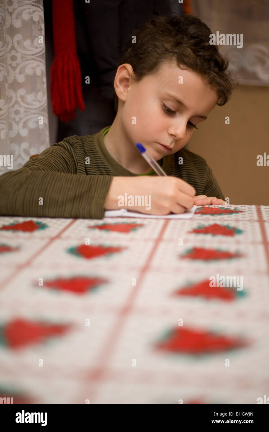 Cute kid writing at a table, very shallow depth of field Stock Photo ...