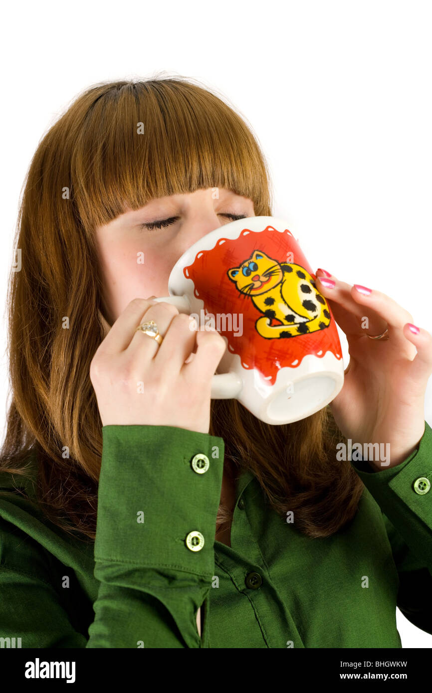 Girl drinking from a cup, isolated on white background Stock Photo - Alamy