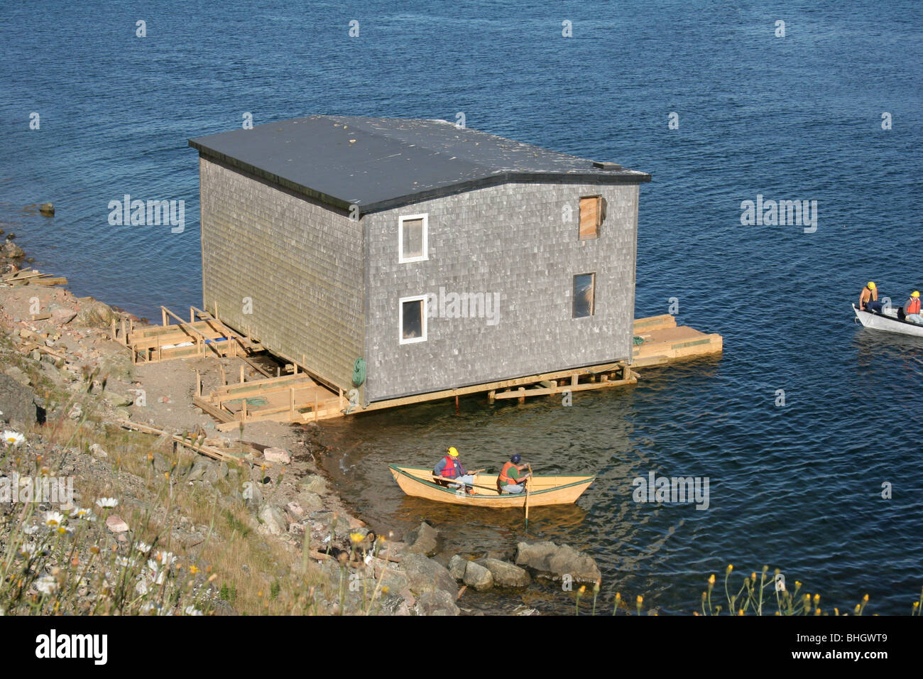 Men of Harbour Breton, Newfoundland prepare to float a building across ...