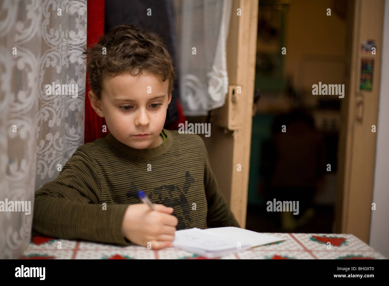 Cute kid writing at a table, very shallow depth of field Stock Photo ...