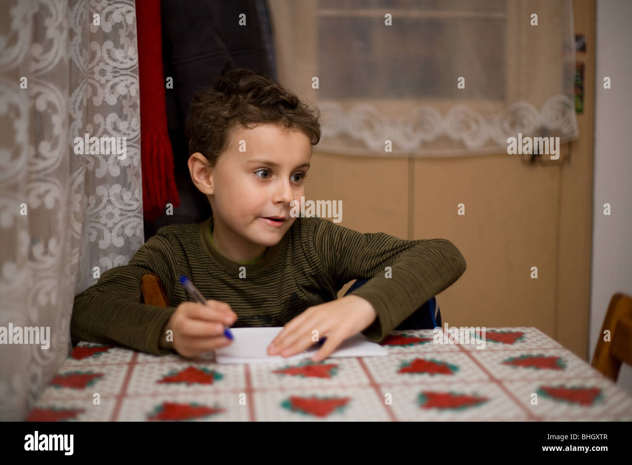 Cute kid writing at a table, very shallow depth of field Stock Photo ...